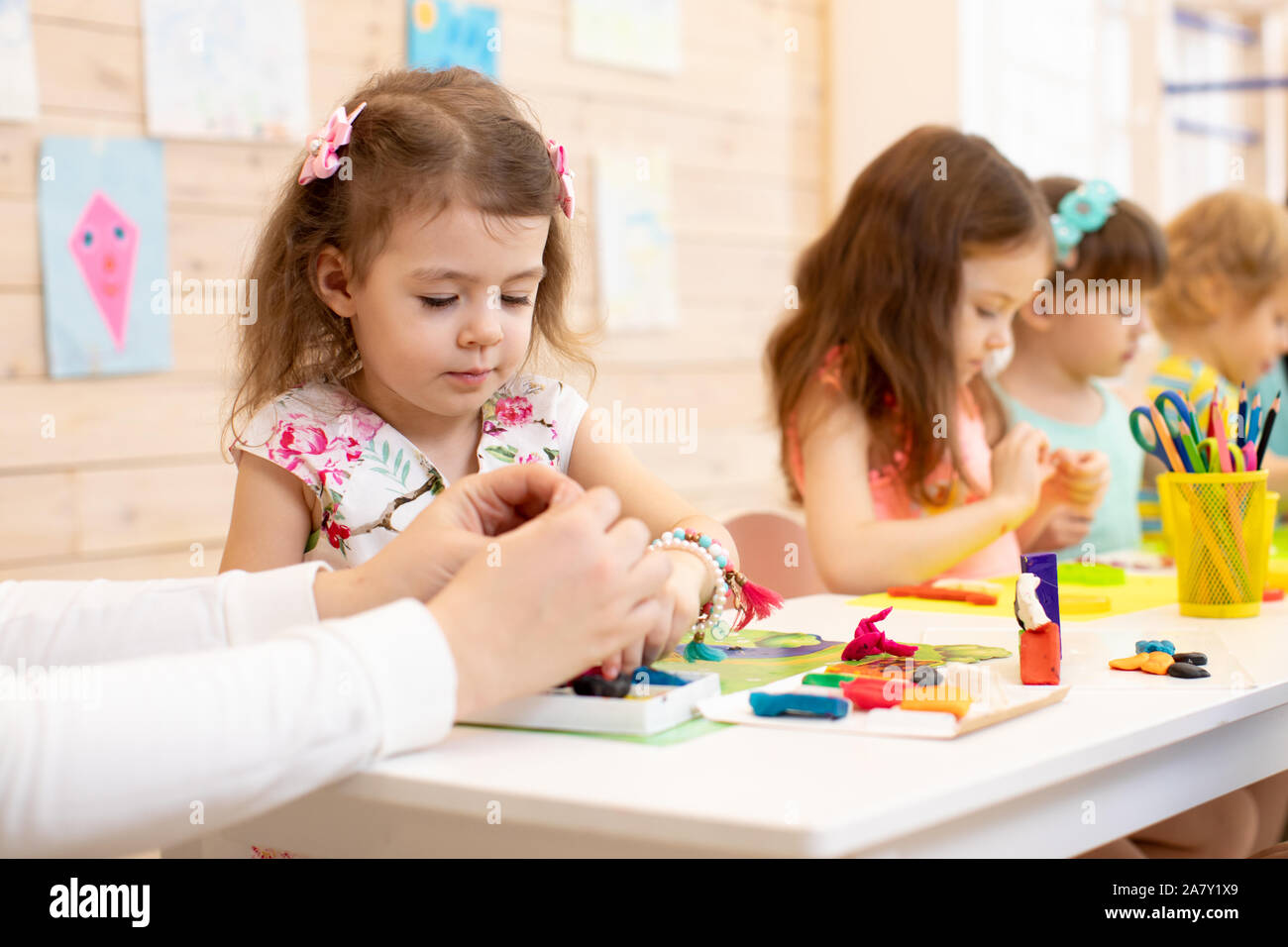 Art and craft activity in kindergarten. Preschool kids hands working in ...