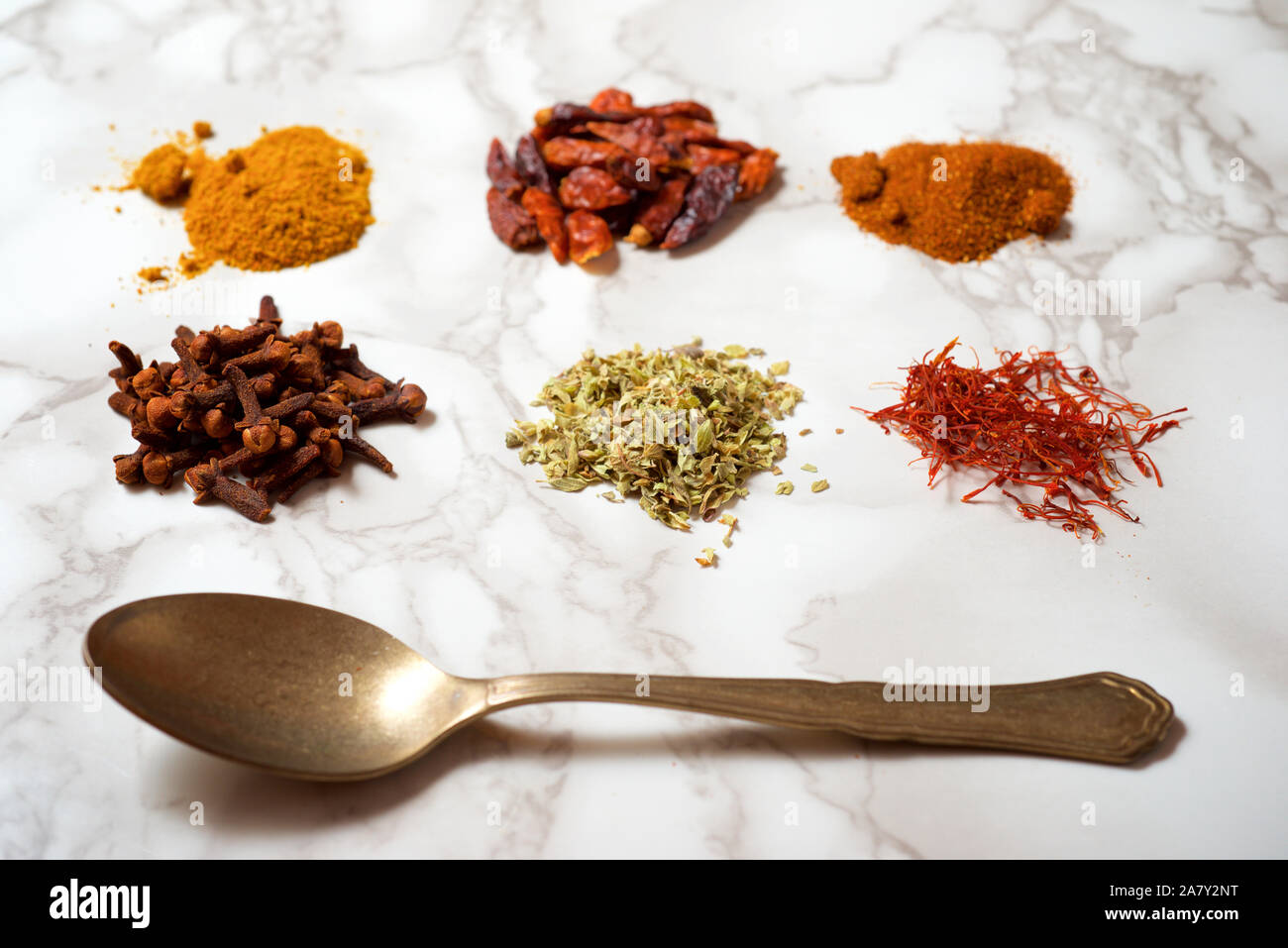Spices on a marble table Stock Photo - Alamy