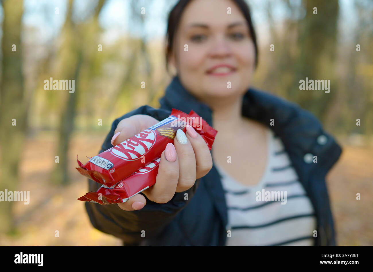 KHARKOV, UKRAINE - OCTOBER 21, 2019: A young girl passes a Kit kat ...