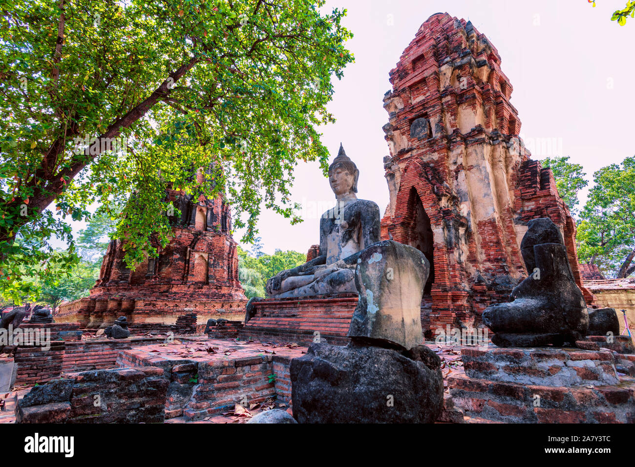 Crumbling temple structures in mid day with blue skies around the ...