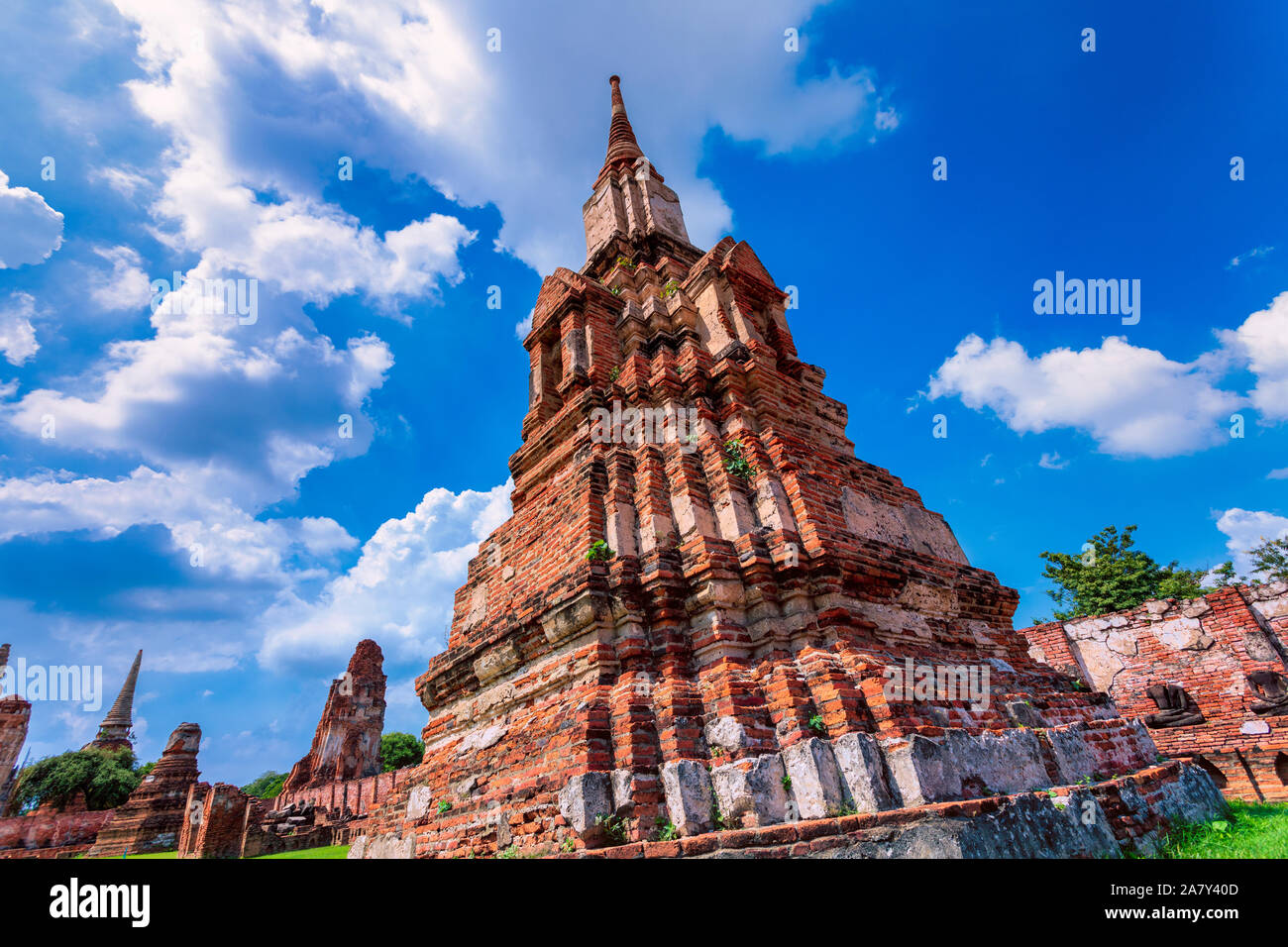 Crumbling temple structures in mid day with blue skies around the ...