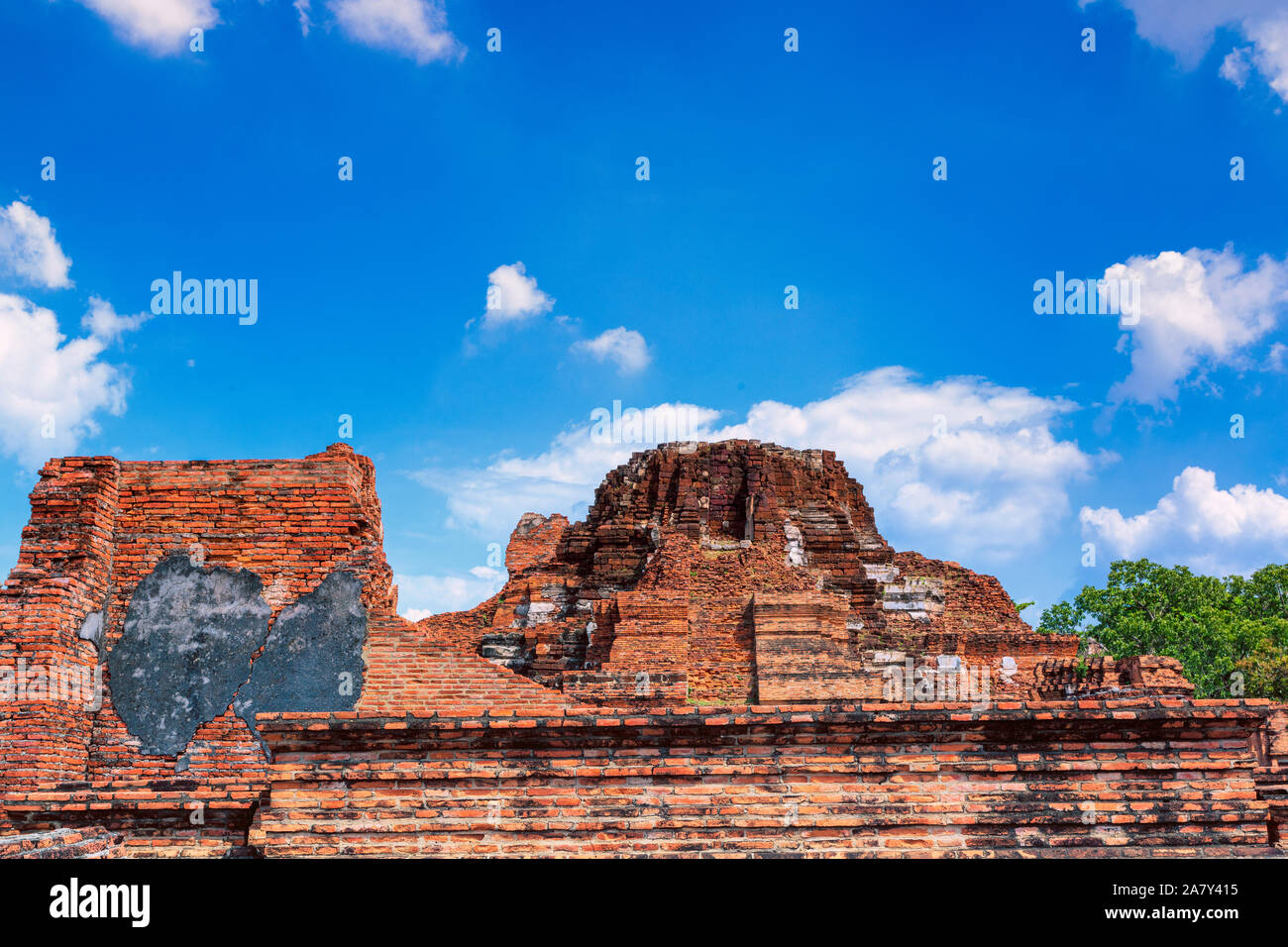 Crumbling temple structures in mid day with blue skies around the ...