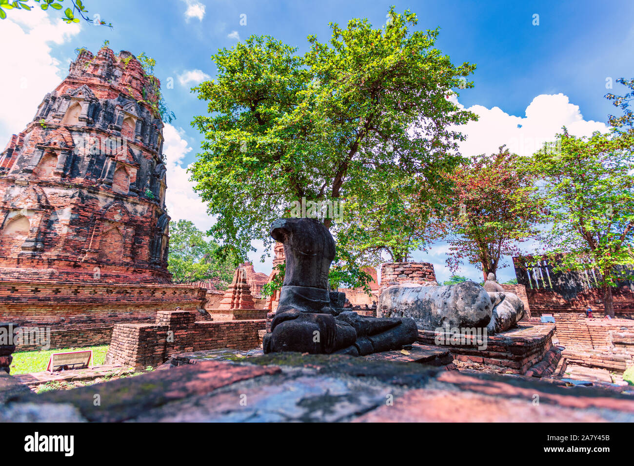 Headless Buddha sits in the center of crumbling temple structures in ...