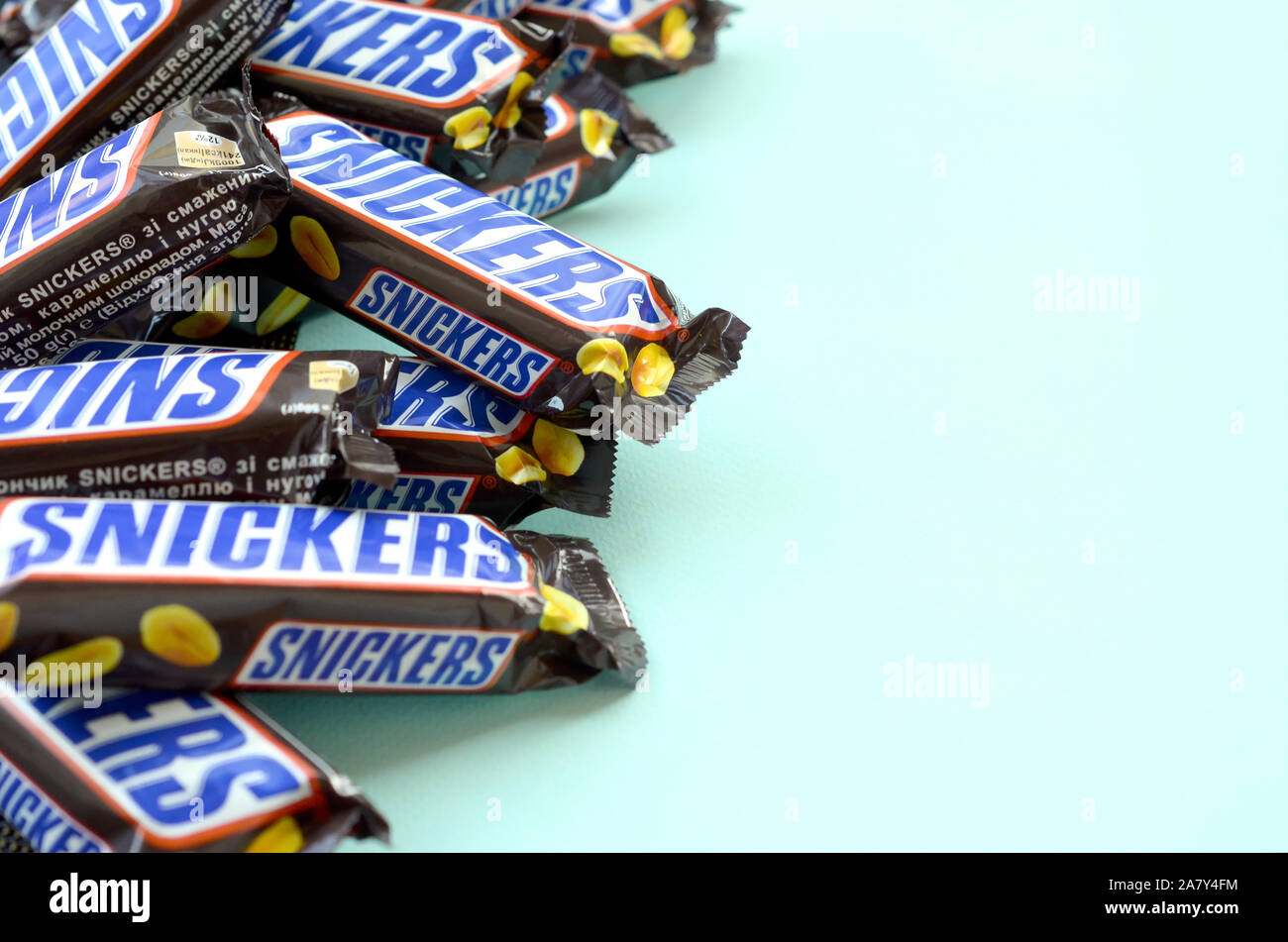 KHARKOV, UKRAINE - OCTOBER 2, 2019: Many Snickers chocolate bars lies ...