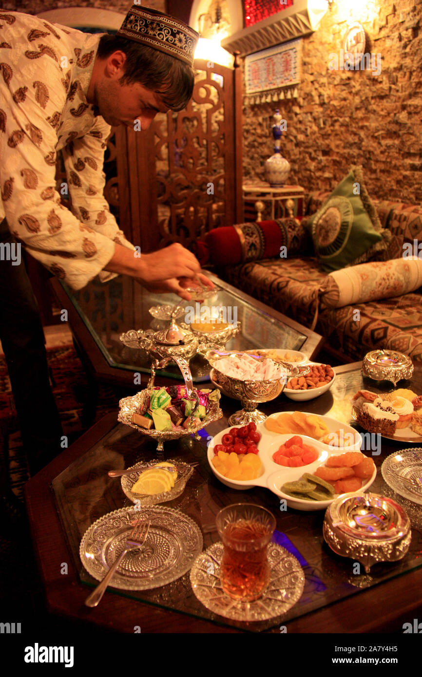 Young man preparing a traditional tea ceremony in a tea house in Baku ...