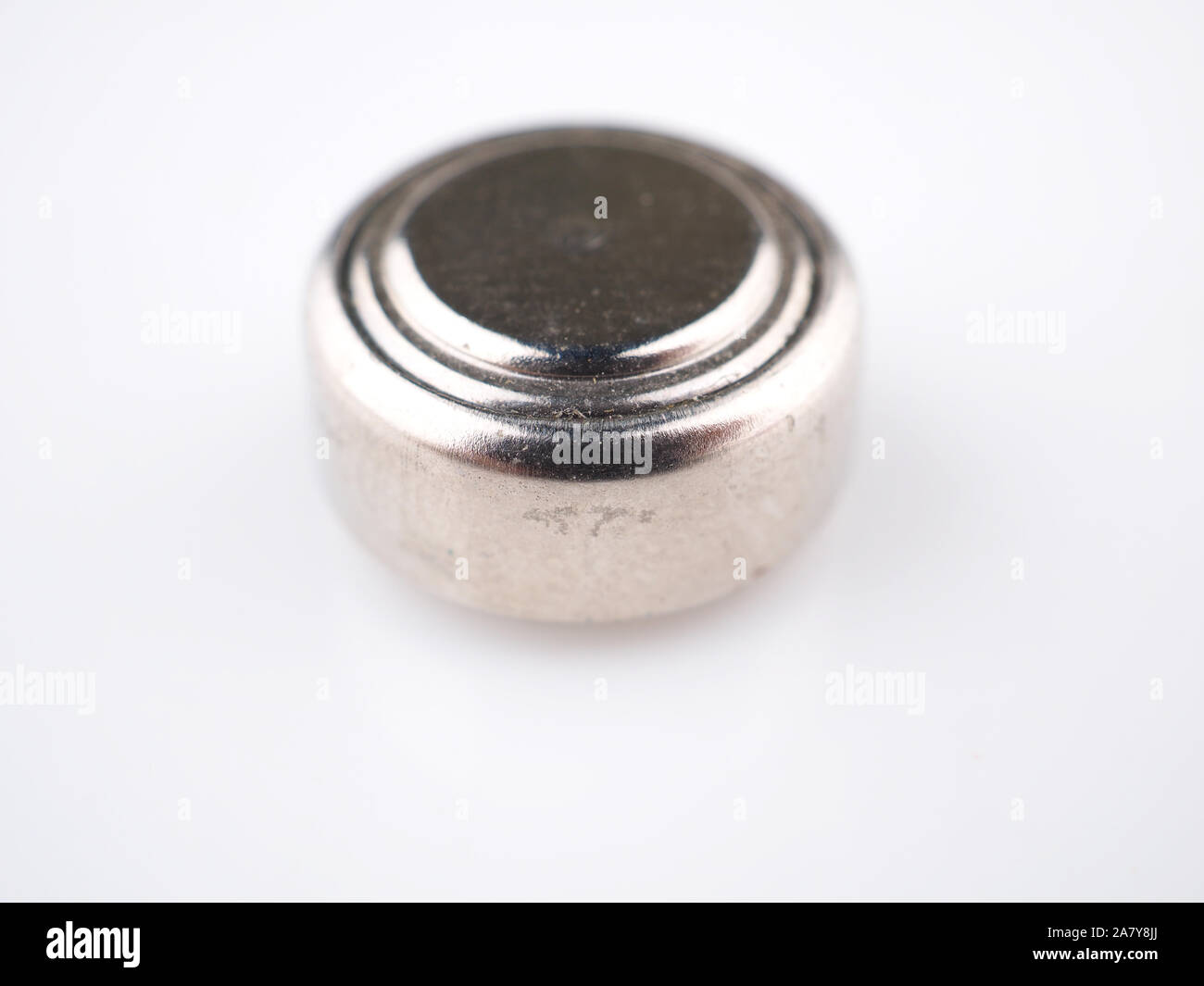 round battery on a gray background Stock Photo - Alamy