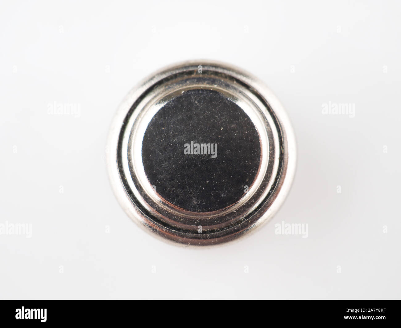 round battery on a gray background Stock Photo - Alamy