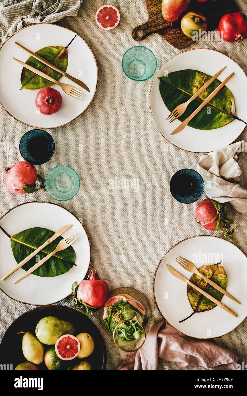 Autumn table setting with seasonal fruits and fallen leaves Stock Photo ...