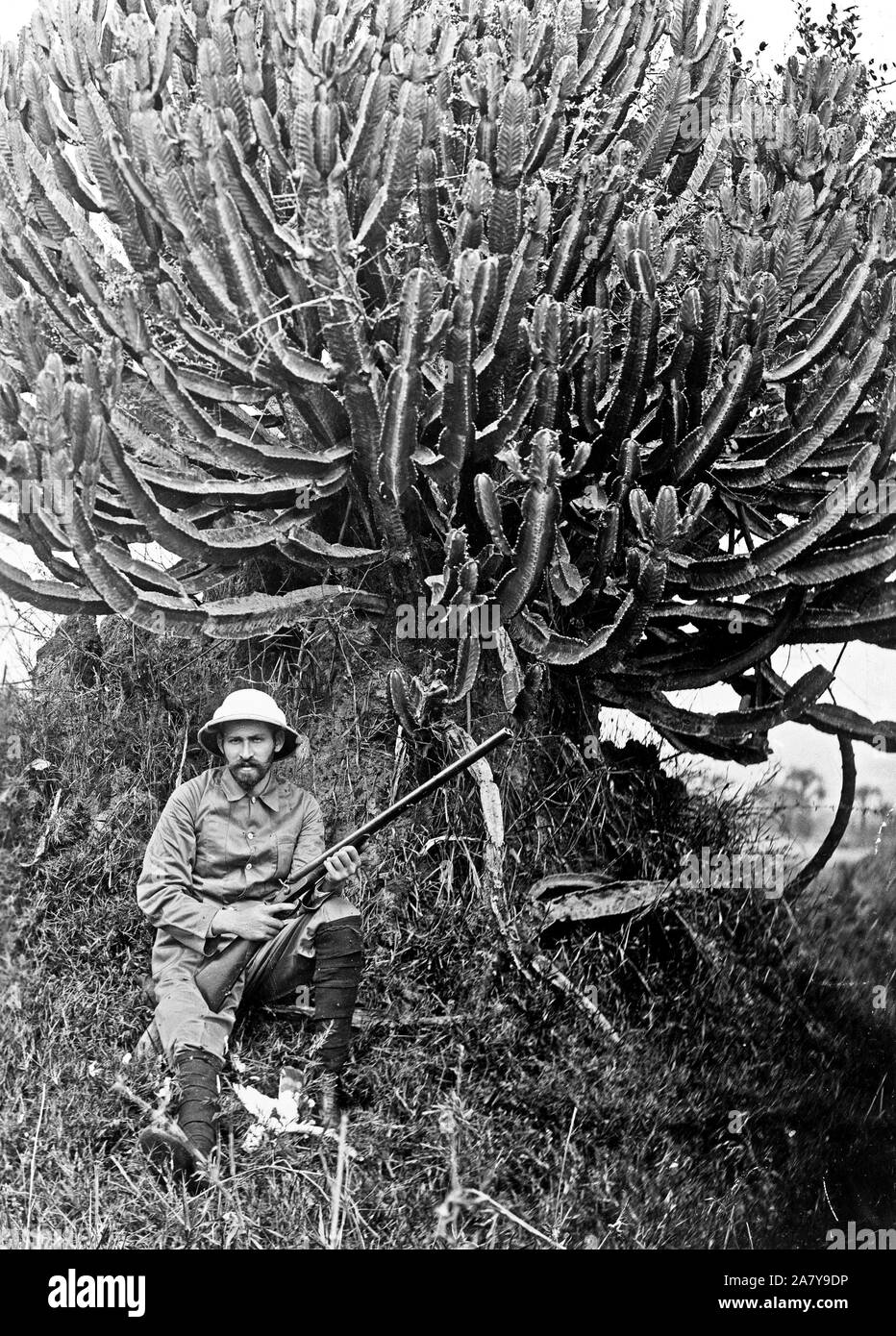 A man, possibly Homer L. Shantz, full-length portrait, holding a rifle ...