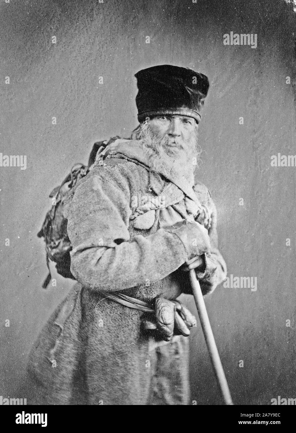 Bearded man, standing, three-quarter length, wearing backpack, with ...