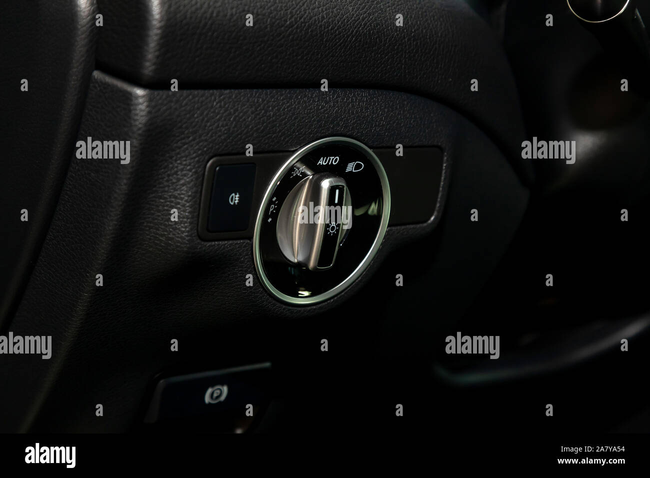 Close-up on the headlight switch control buttons and automatic adjust ...