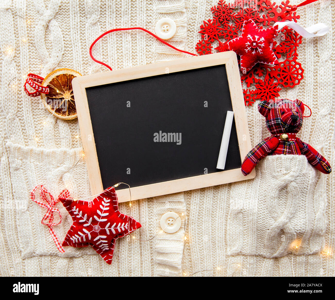 Flat lay view of empty black chalkboard for making Christmas gifts wish ...