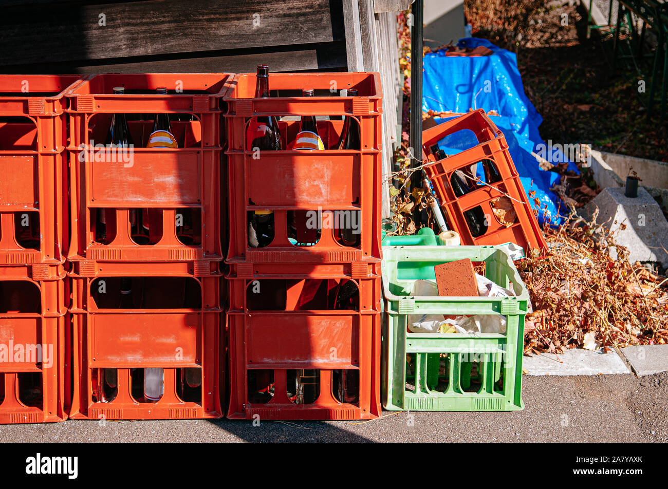 Red beer crate box with empty bottle under bright sunlight high ...