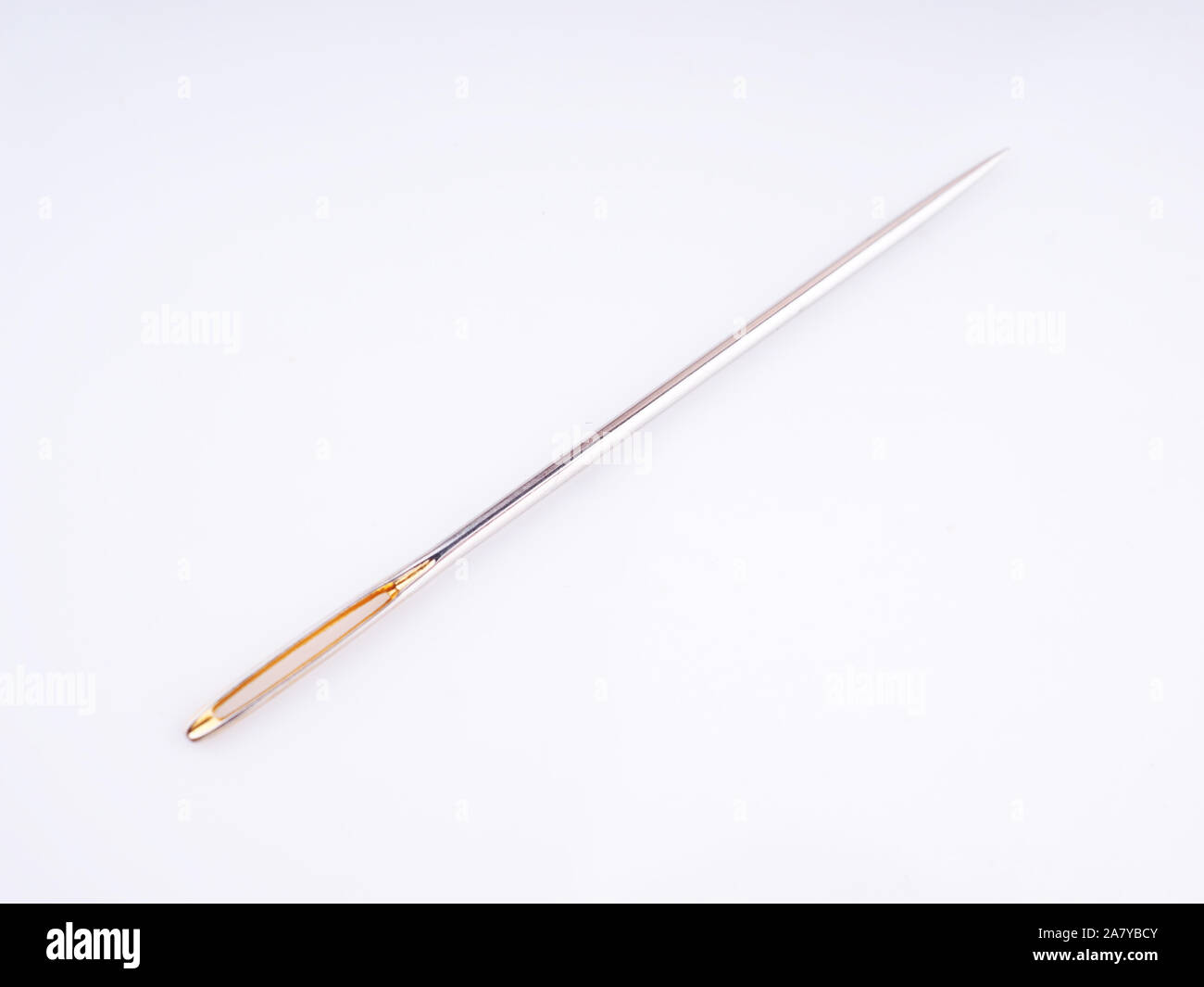 sewing needles on white background Stock Photo - Alamy