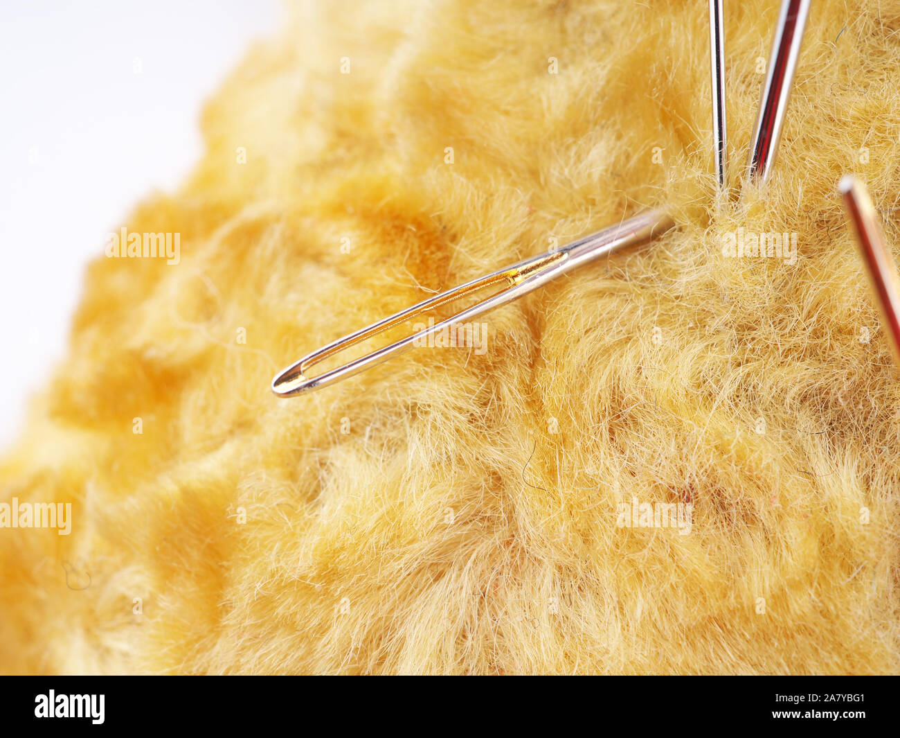 sewing needles on white background Stock Photo - Alamy