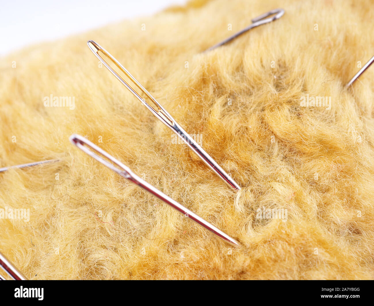 sewing needles on white background Stock Photo - Alamy