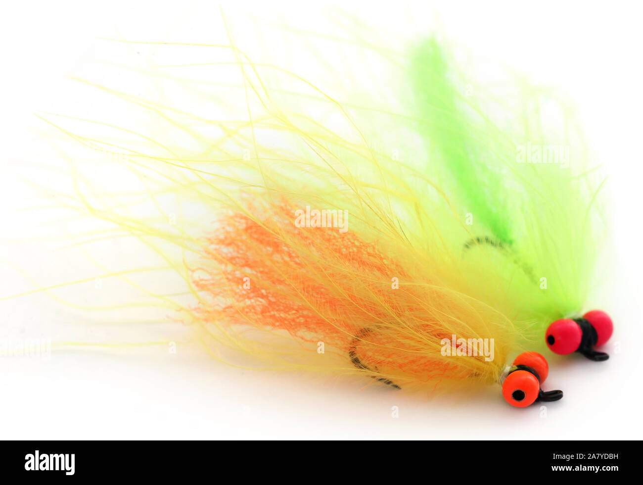 Fishing fly with hook over white background Stock Photo - Alamy