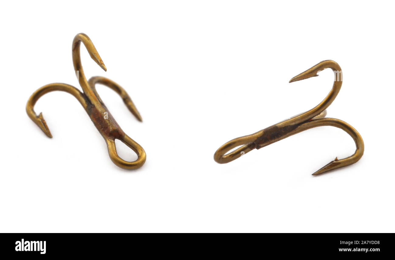 Sharp treble hooks for fishing over white background Stock Photo - Alamy