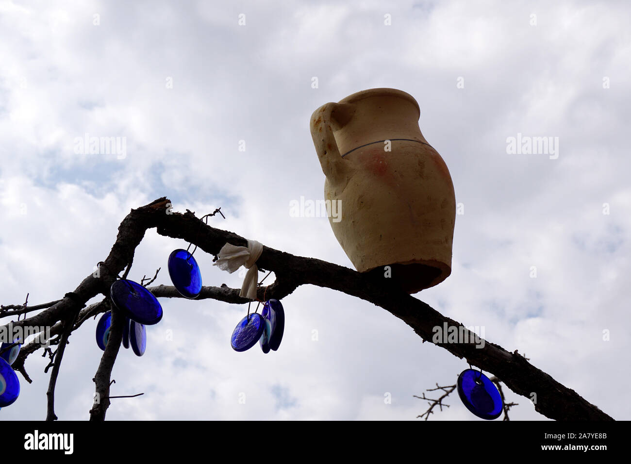 Image of handmade clay pitcher and greek blue evil eyes hanging on ...