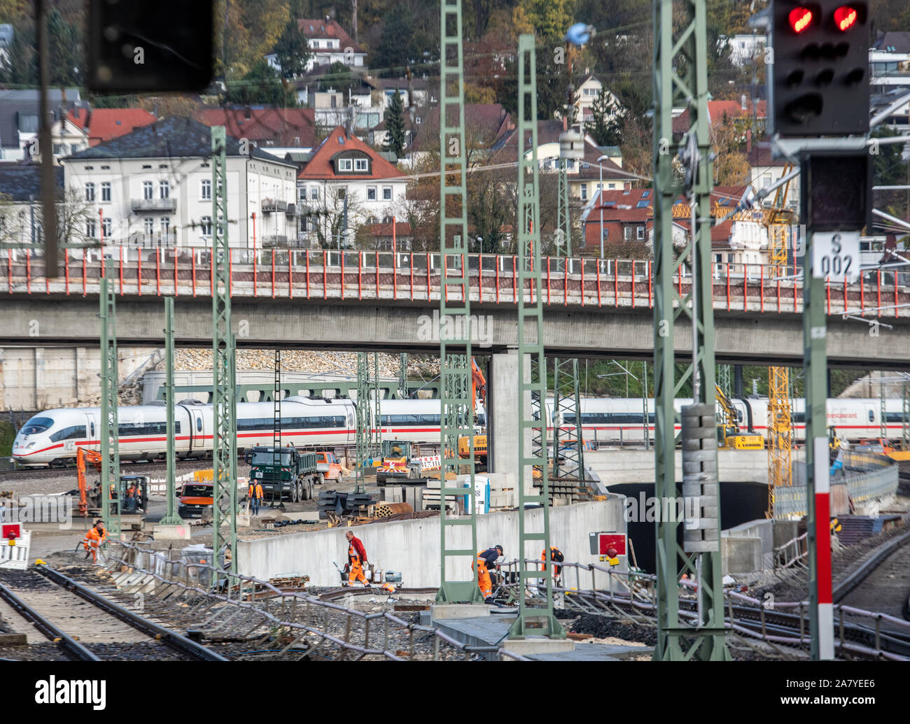 Ulm, Germany. 05th Nov, 2019. A train passes track workers at the main ...