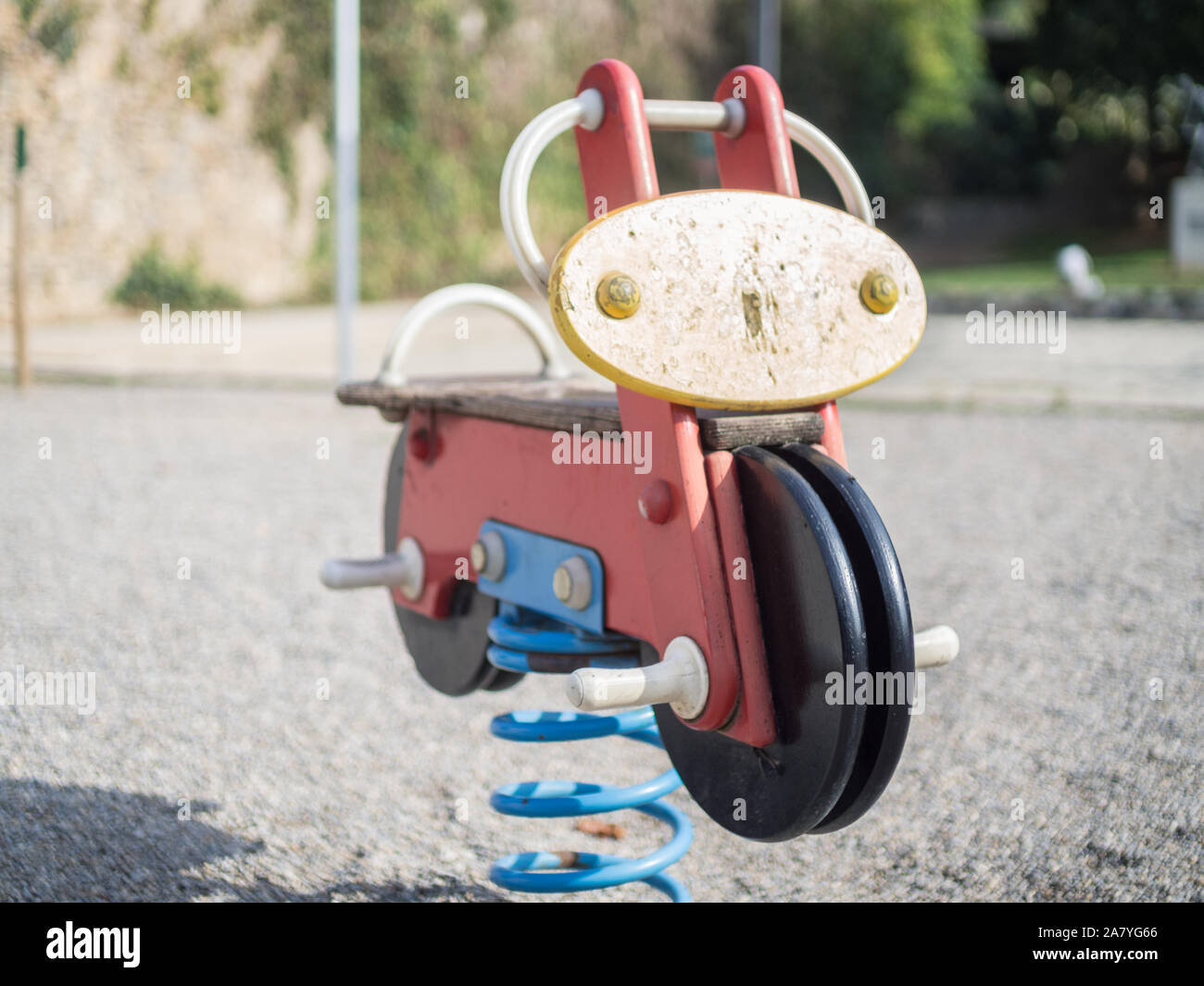 metal spring with a colorful motorcycle in a children playground Stock ...