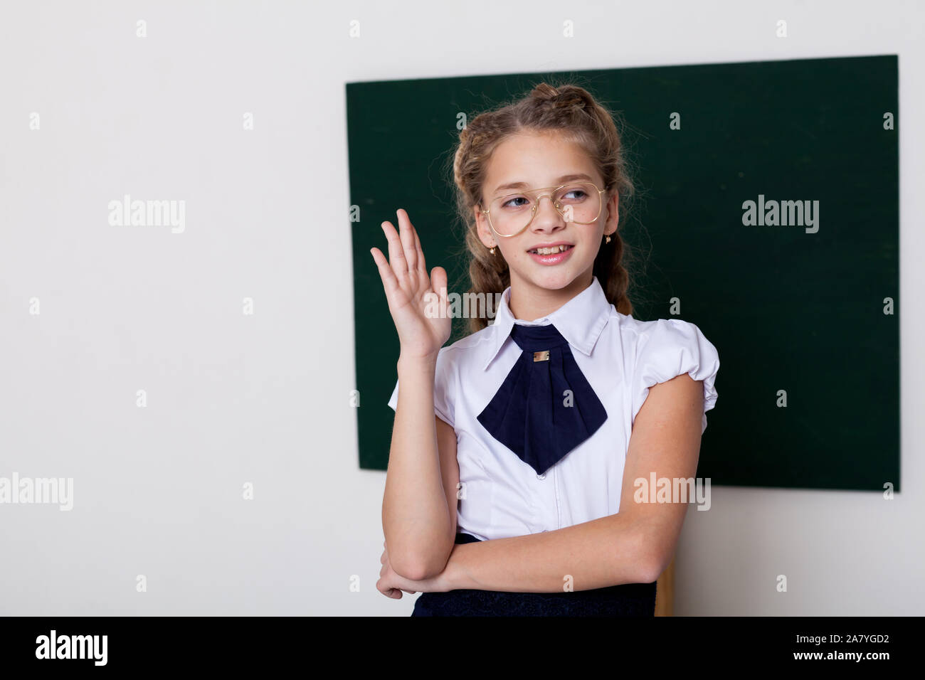 Schoolgirl girl with glasses in class by green board Stock Photo - Alamy