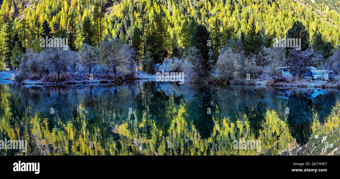 Autumn landscape with reflection in a lake in the alpine mountainsю ...