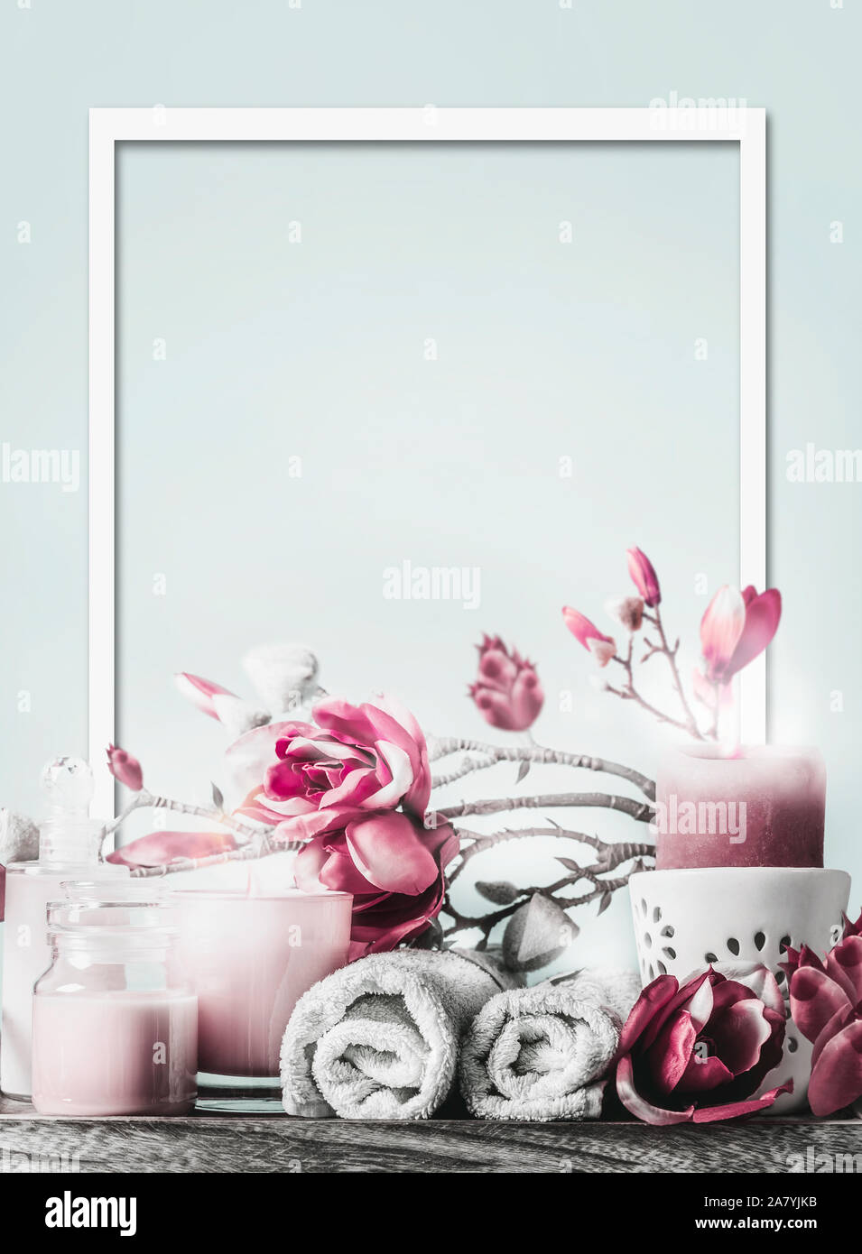 Wellness frame with body care cosmetic products, candles, flowers and ...