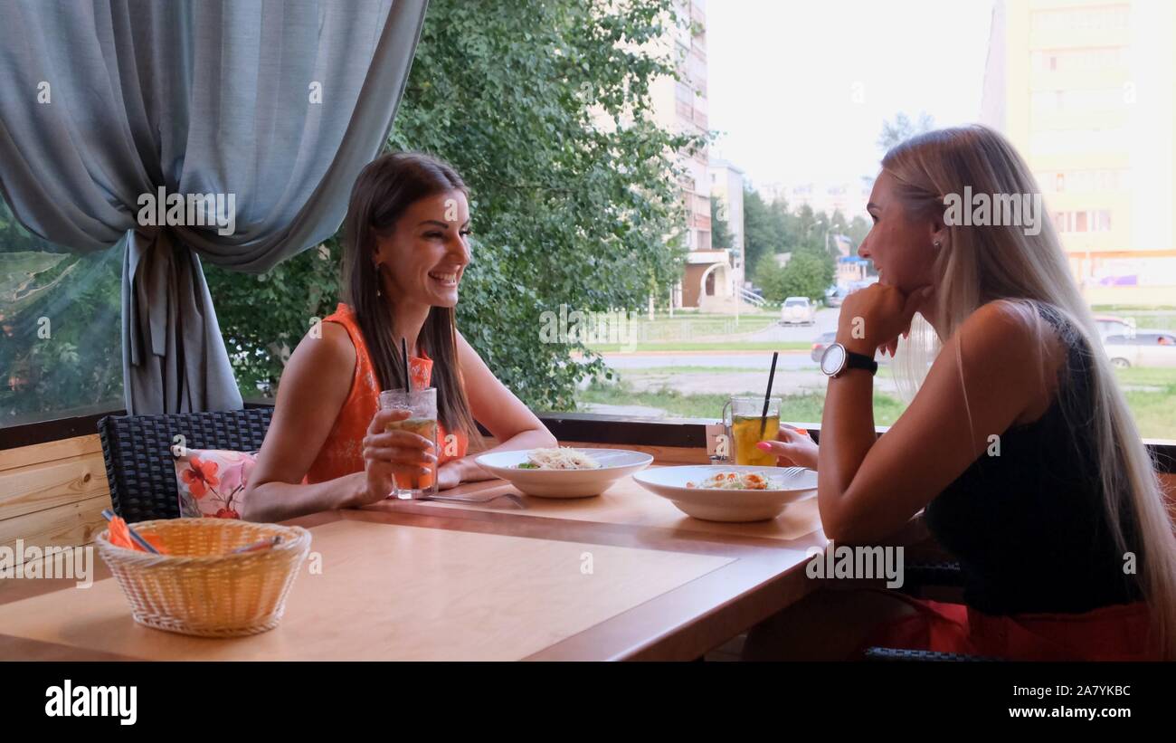 Two friends in a cafe-bar drink cocktails on an open terrace Stock ...