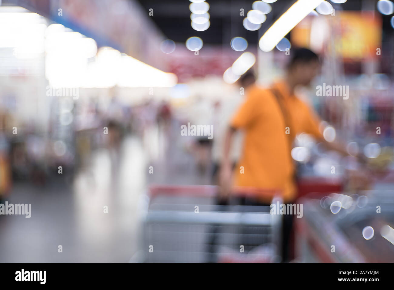 Abstract blurred supermarket aisle with colorful shelves and ...