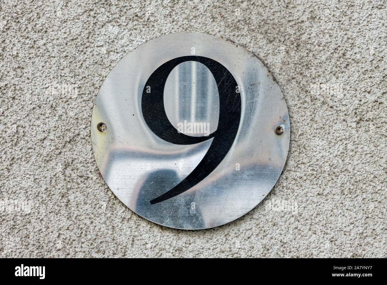 Street number sign on the wall Stock Photo - Alamy