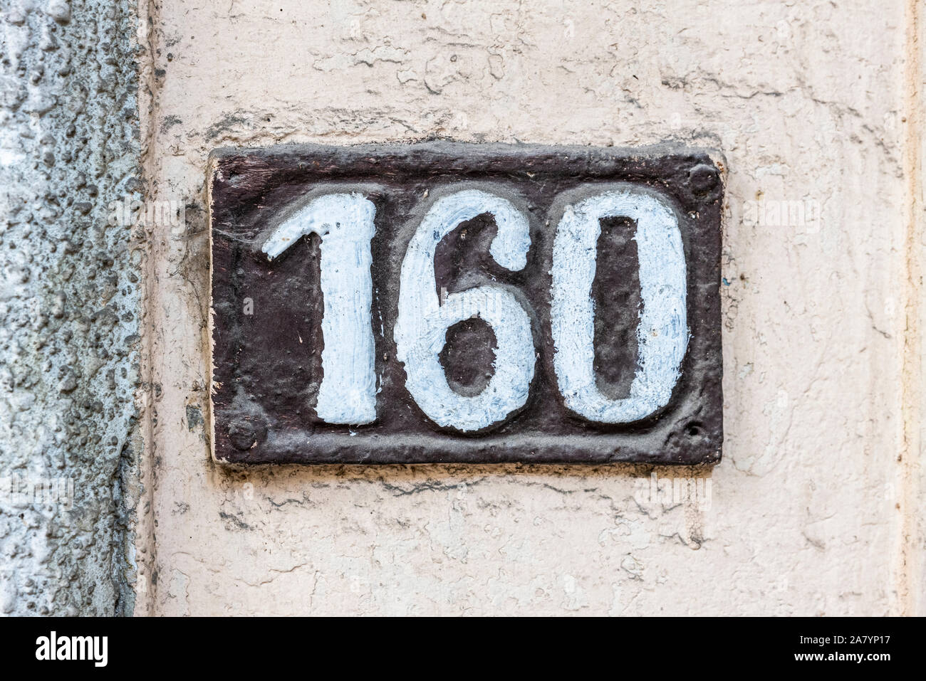 Street number sign on the wall Stock Photo - Alamy