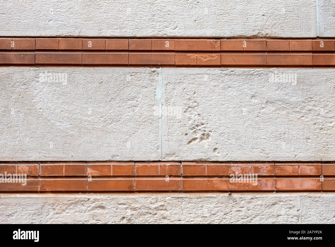 Stone wall with a lines of bricks Stock Photo - Alamy