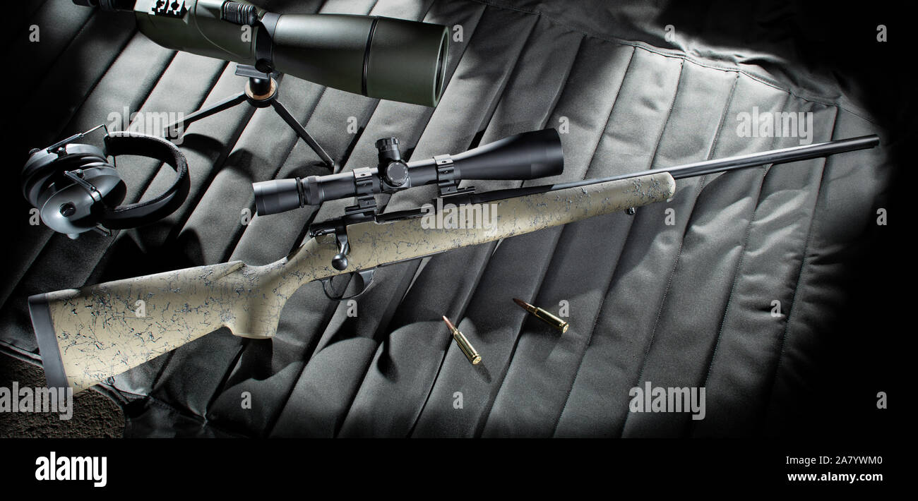 Bolt action rifle and shooting gear on a gray shooting mat Stock Photo ...