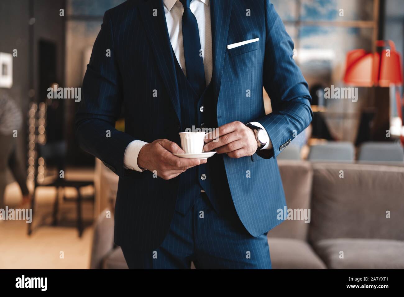 Confident man in smart casual wear holding coffee cup at his working ...