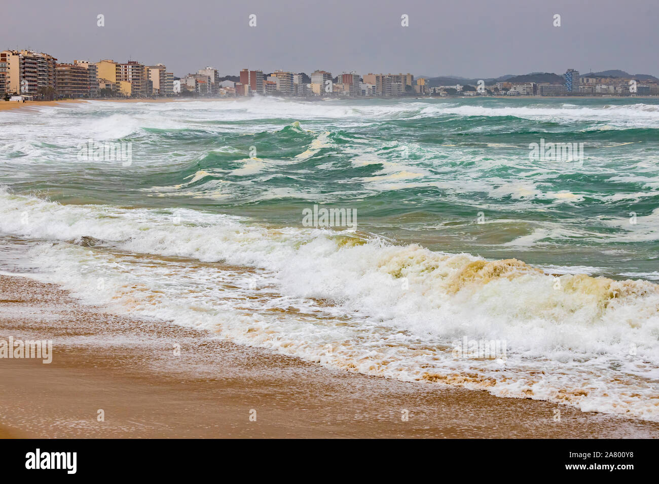 Big waves splashing on the beach in a spanish coastal, near the town ...