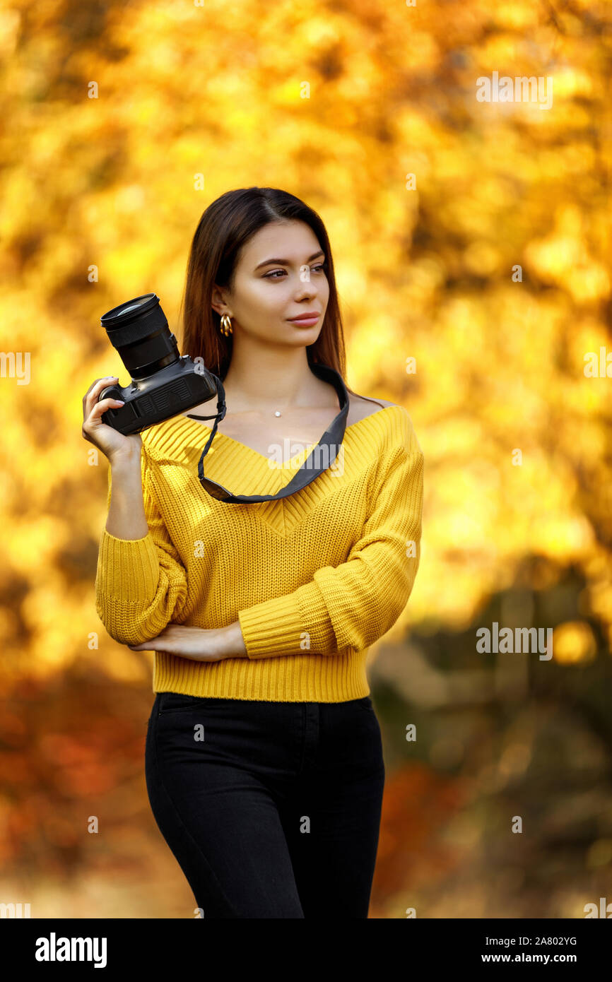 cute girl photographer takes pictures in nature, the photographer in ...