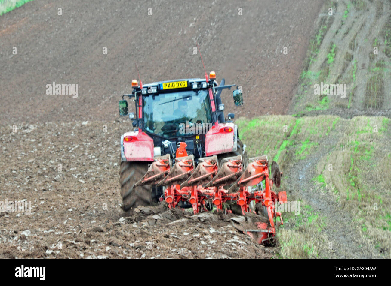 Ploughing by tractor Stock Photo - Alamy