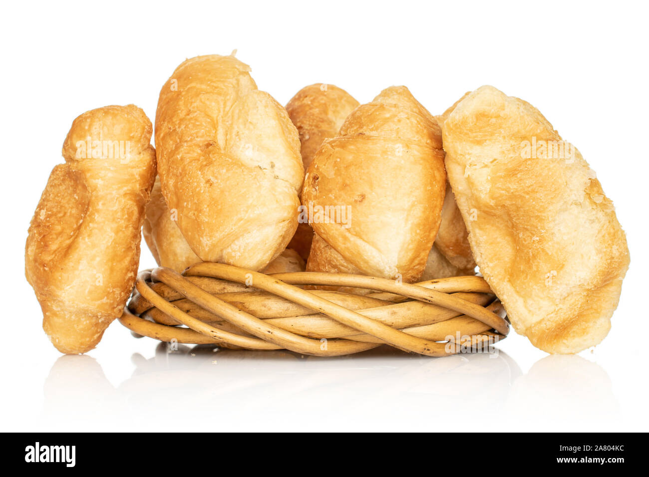 Group of five whole fresh baked mini croissant in wicker vine circle ...