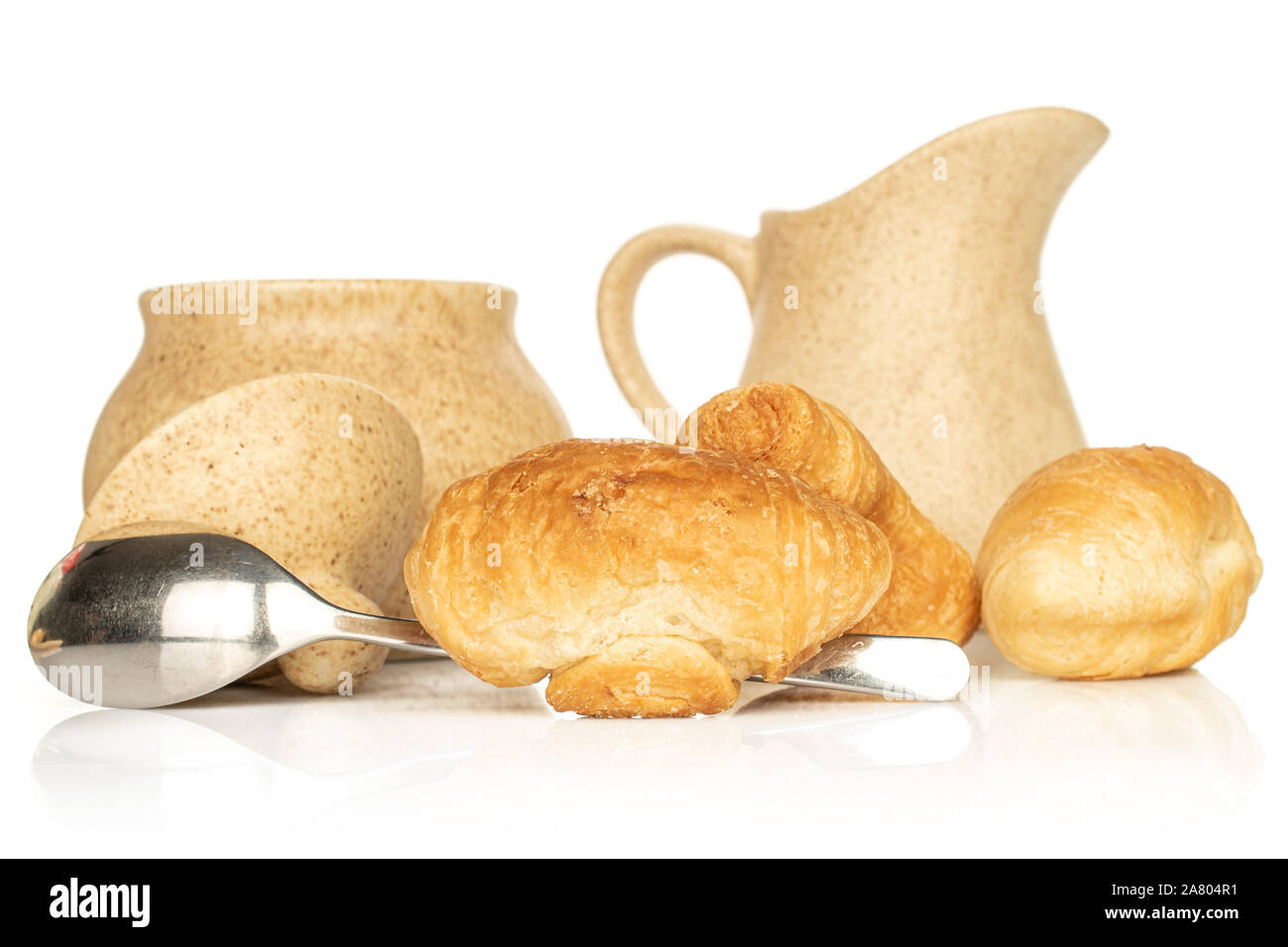 Group of three whole fresh baked mini croissant with sugar bowl ...
