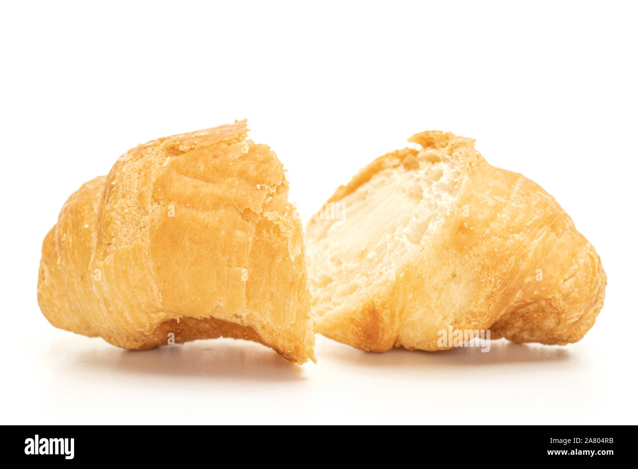 Group of two halves of fresh baked mini croissant one sliced isolated ...