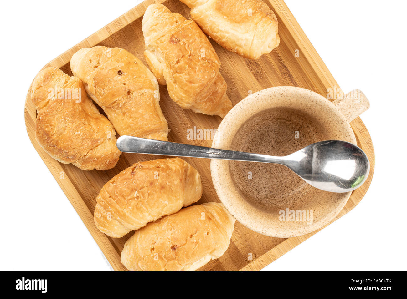 Group of six mini croissants on bamboo plate with cup flatlay isolated ...