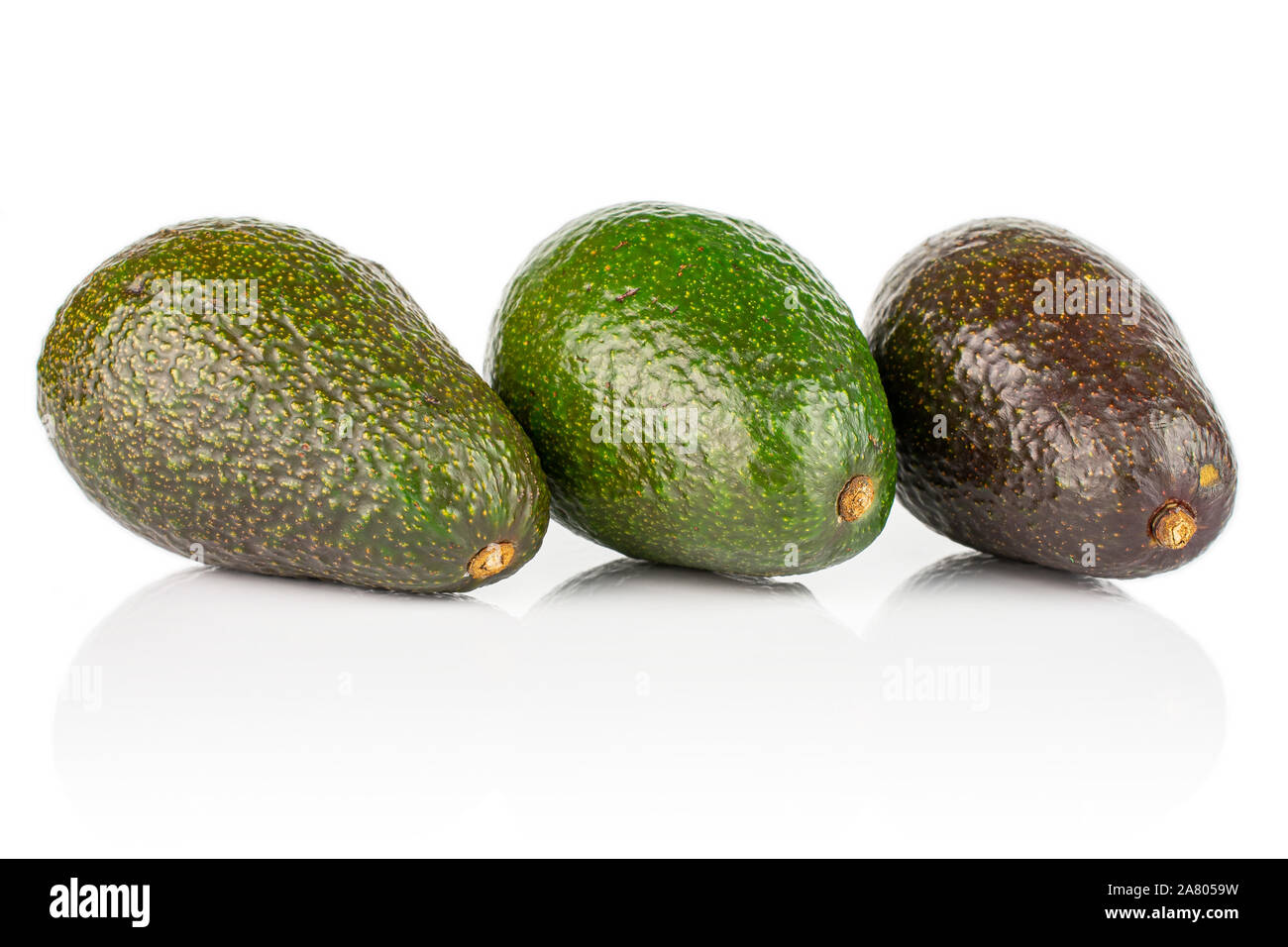 Group of three whole fresh green avocado isolated on white background ...