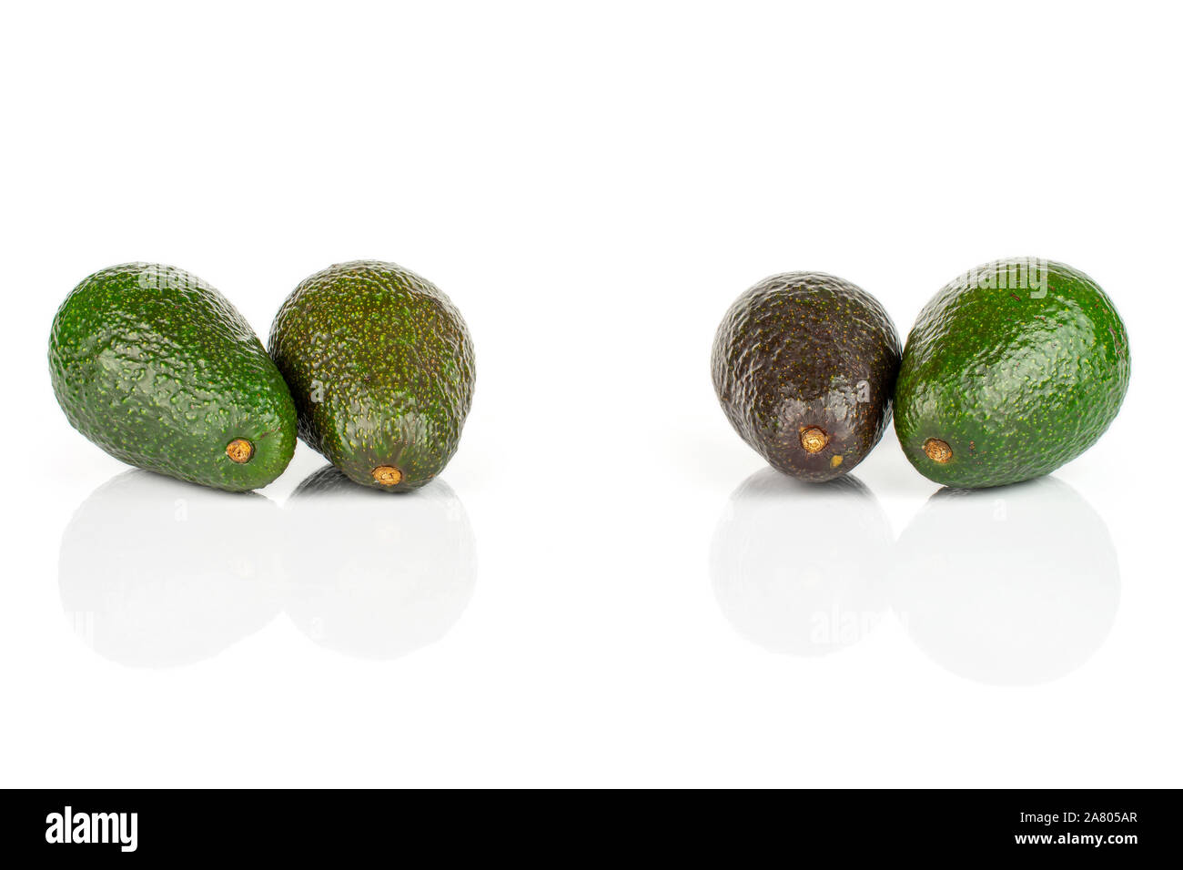 Group of four whole fresh green avocado isolated on white background ...