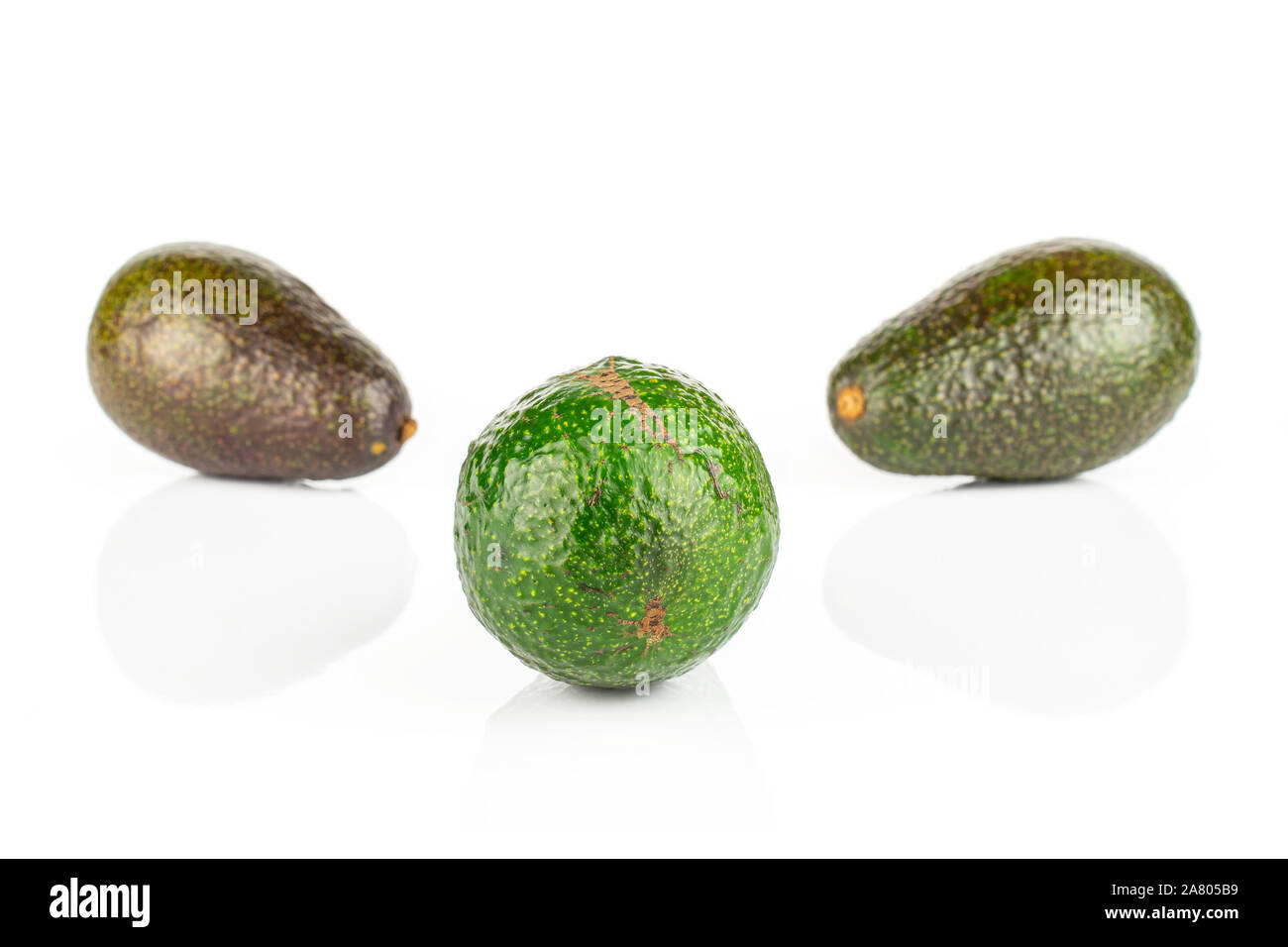 Group of three whole fresh green avocado isolated on white background ...