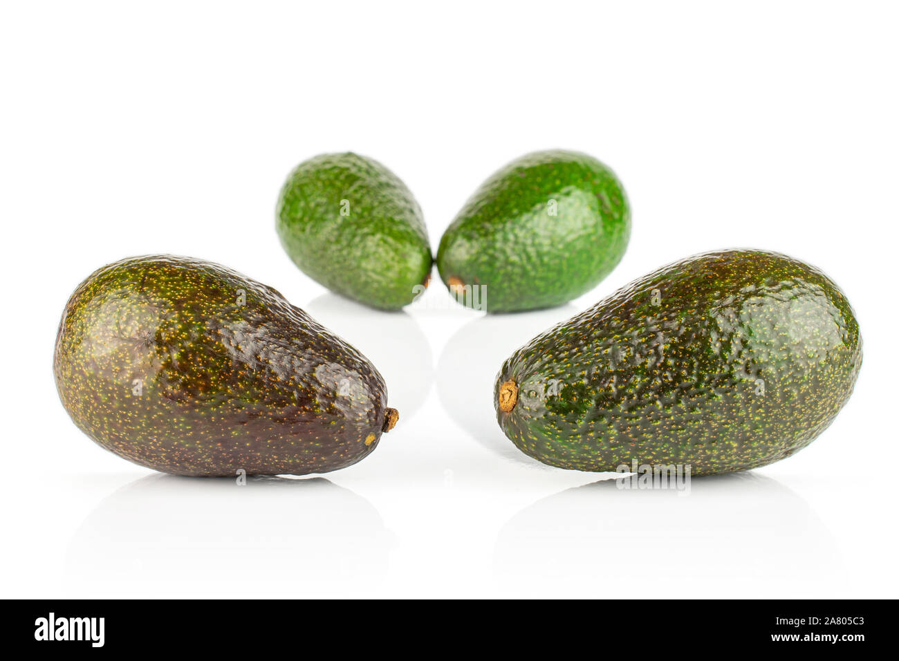 Group of four whole fresh green avocado isolated on white background ...