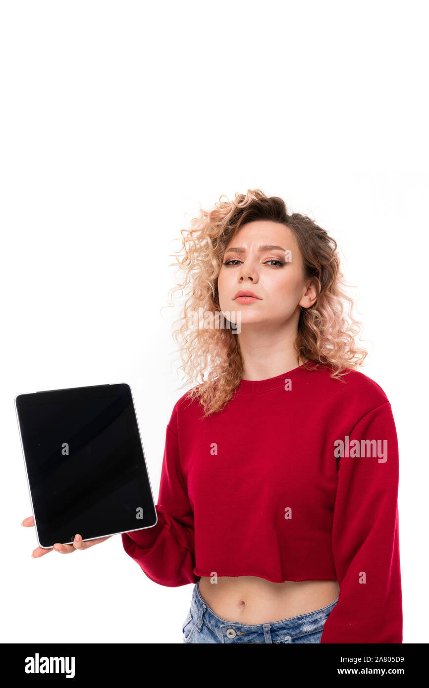 Caucasian girl with curly fair hair holds a tablet , portrait isolated ...