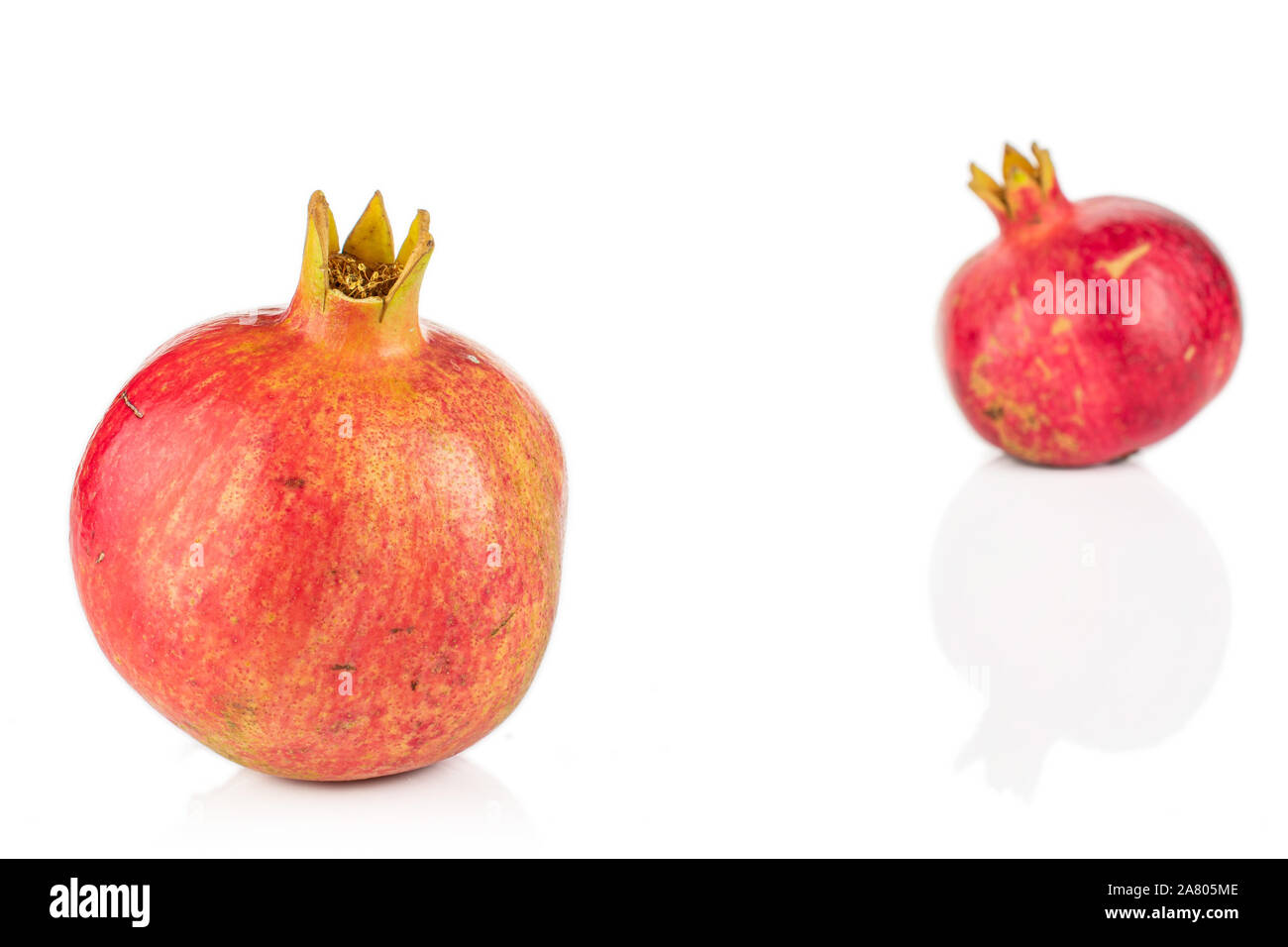 Group of two whole fresh red pomegranate e isolated on white background ...