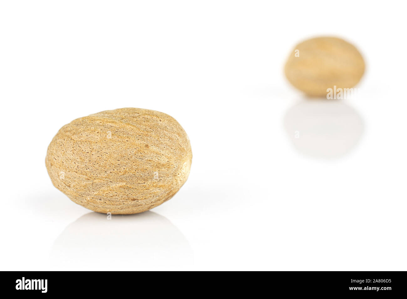 Group of two whole dry brown nutmeg isolated on white background Stock ...