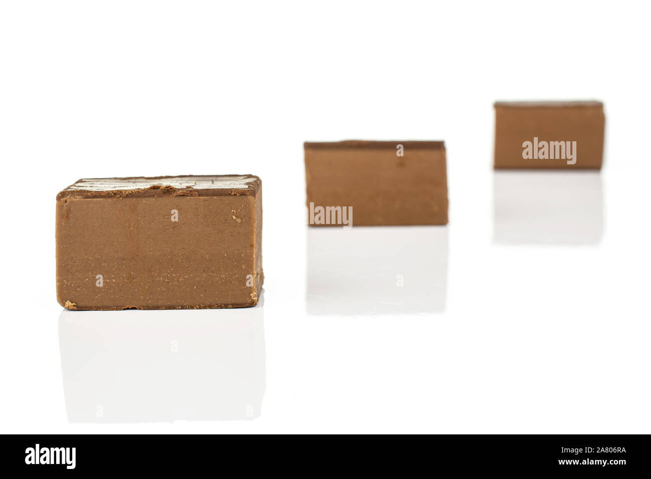 Group of three whole sweet brown viennese nougat placed diagonally ...